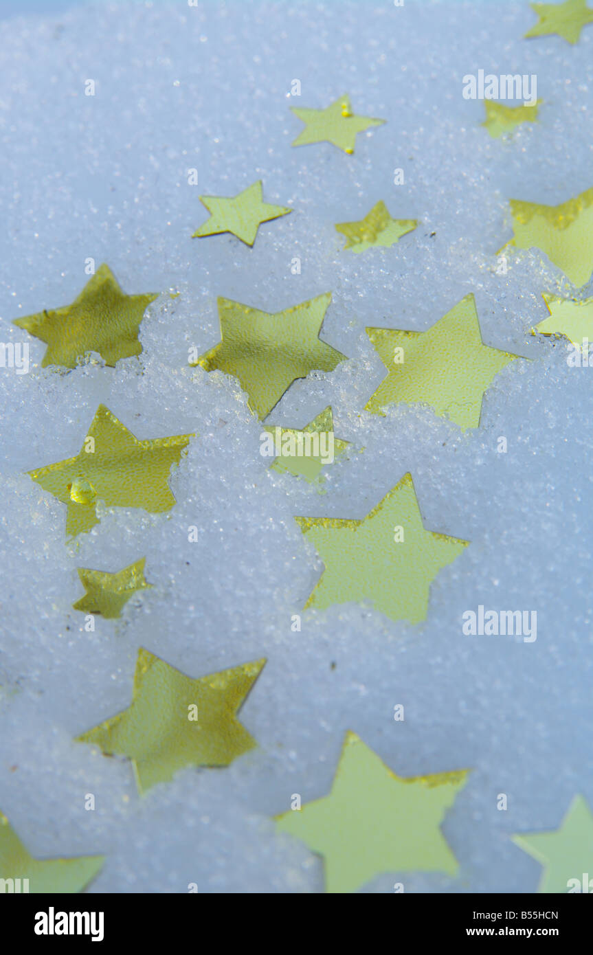 golden snow stars on a real snowy icy surface Stock Photo - Alamy