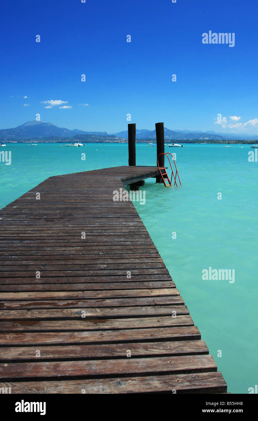 a small jetty in lake Garda Italy fantastic color in the water and sky ...