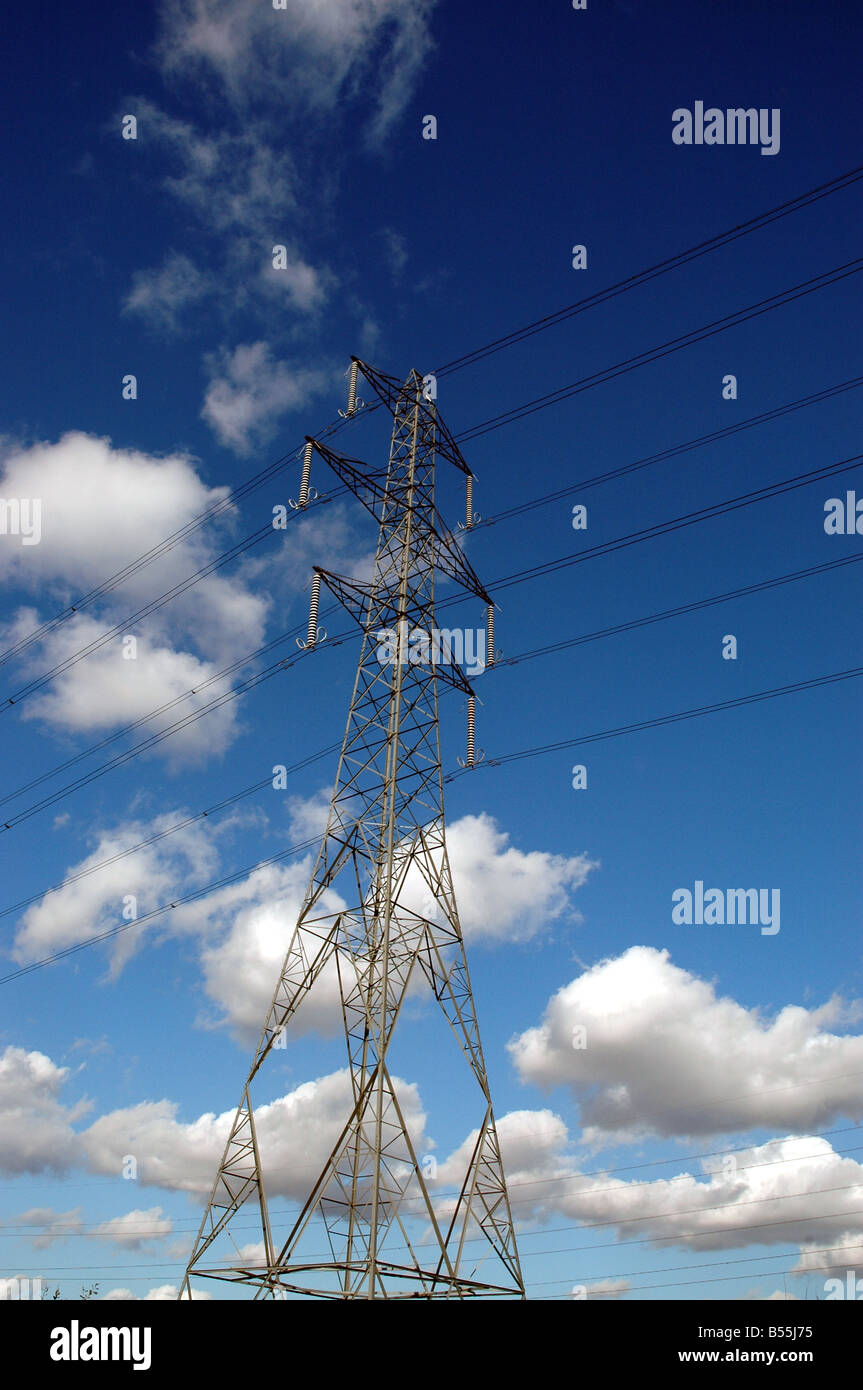 An electricity pylon with blue sky above Stock Photo - Alamy
