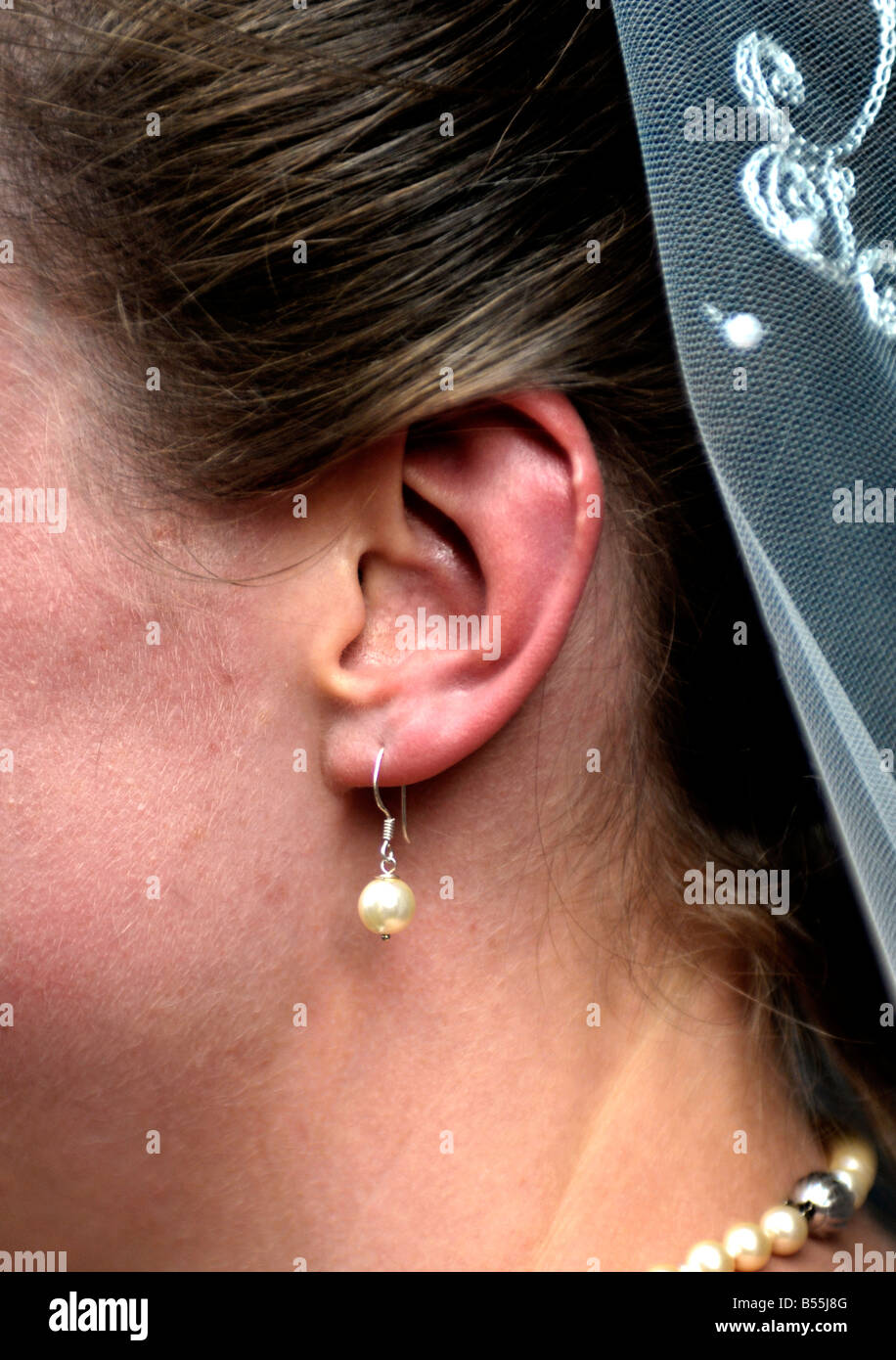 Earing women hi-res stock photography and images - Alamy