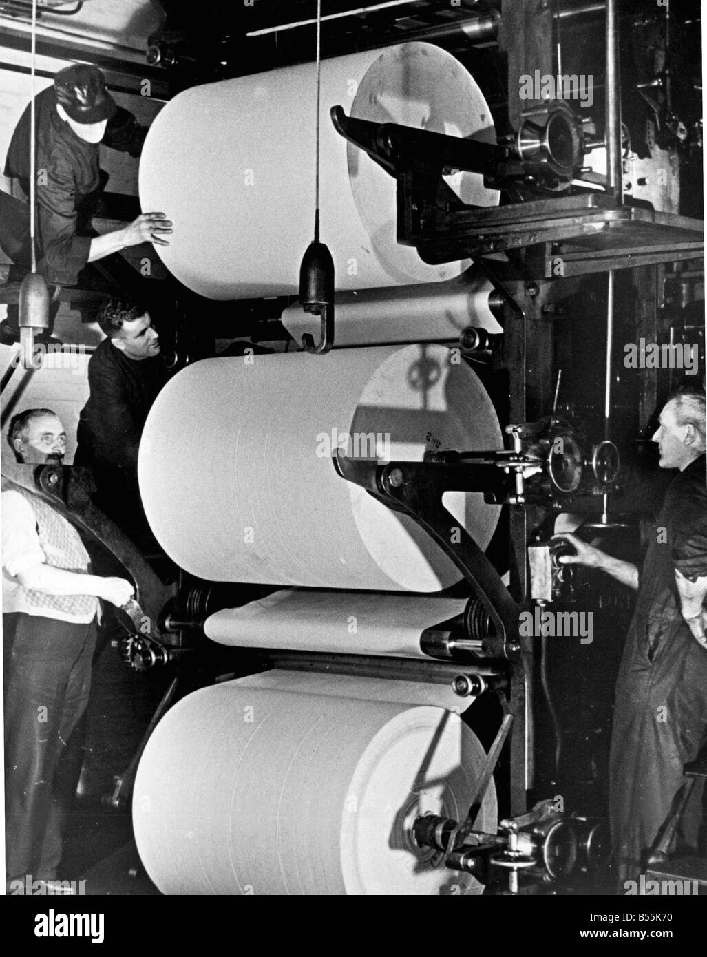 Printers Circa 1950 Reels of paper are loaded and threaded into the ...