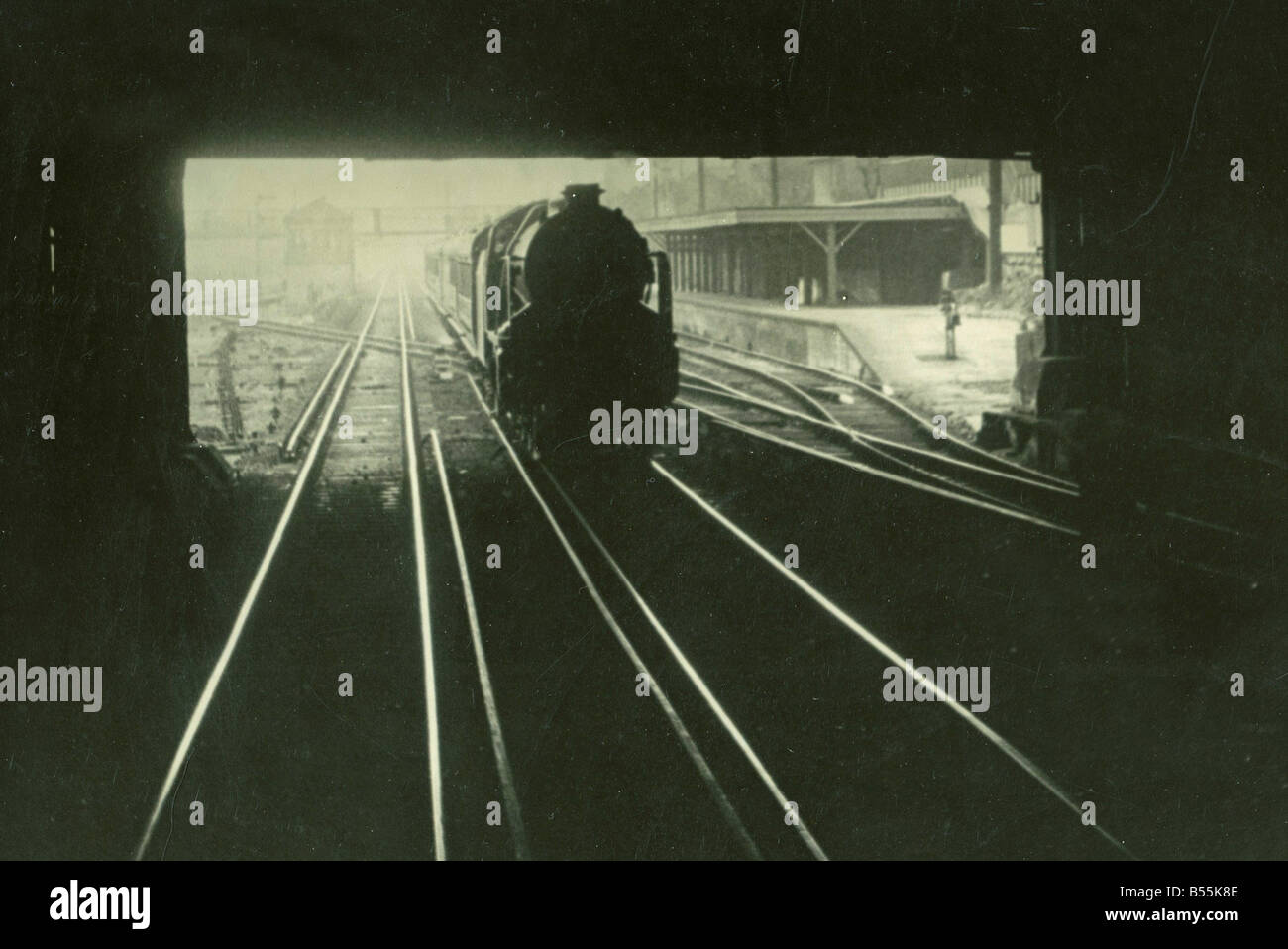 Steam Engine pulling out of unknown station under a bridge. c.1950 ...