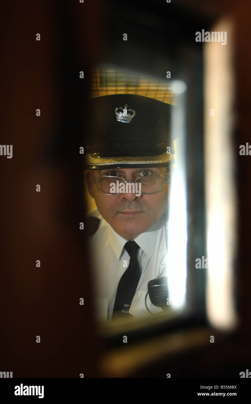 Prison Officer looking through a cell door in 'A' Hall in Craiginches ...