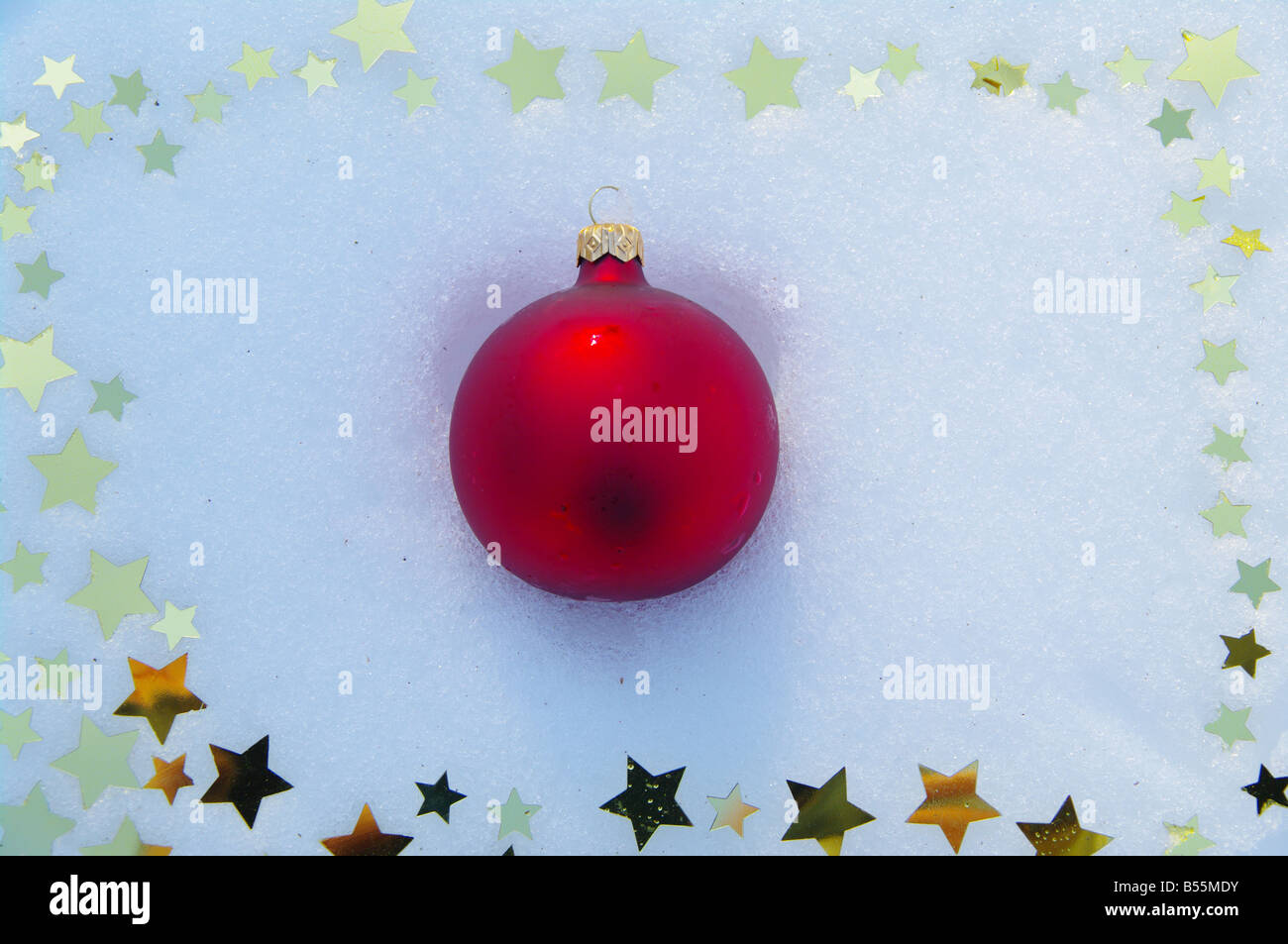 golden snow stars on a real snowy icy surface Stock Photo - Alamy
