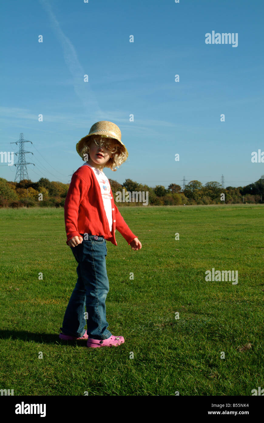 Little girl playing in the countryside Stock Photo - Alamy