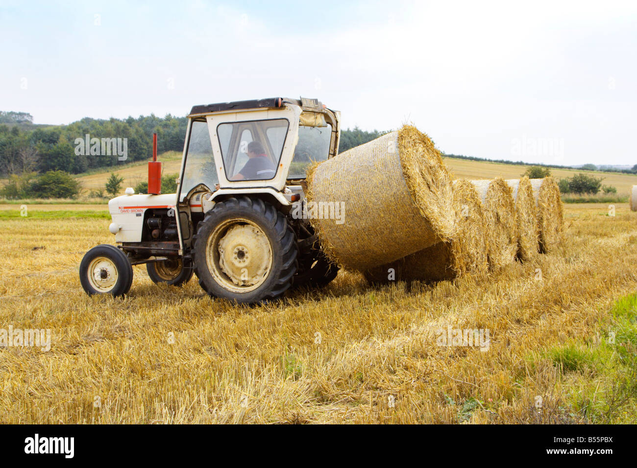 tractor gathering hay bales Stock Photo - Alamy