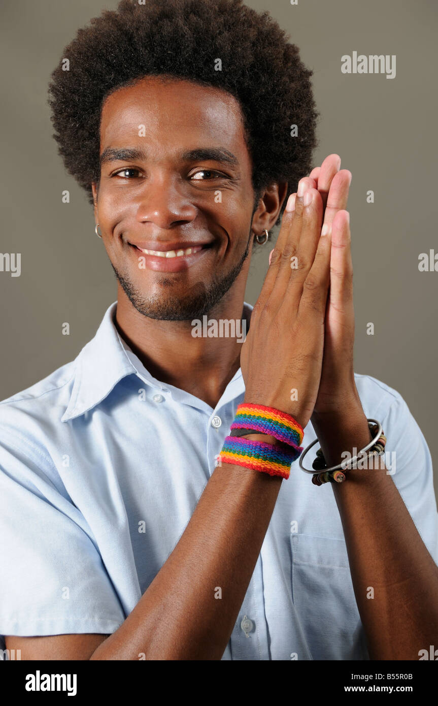 Portrait of young positive african male model with pleased expression ...