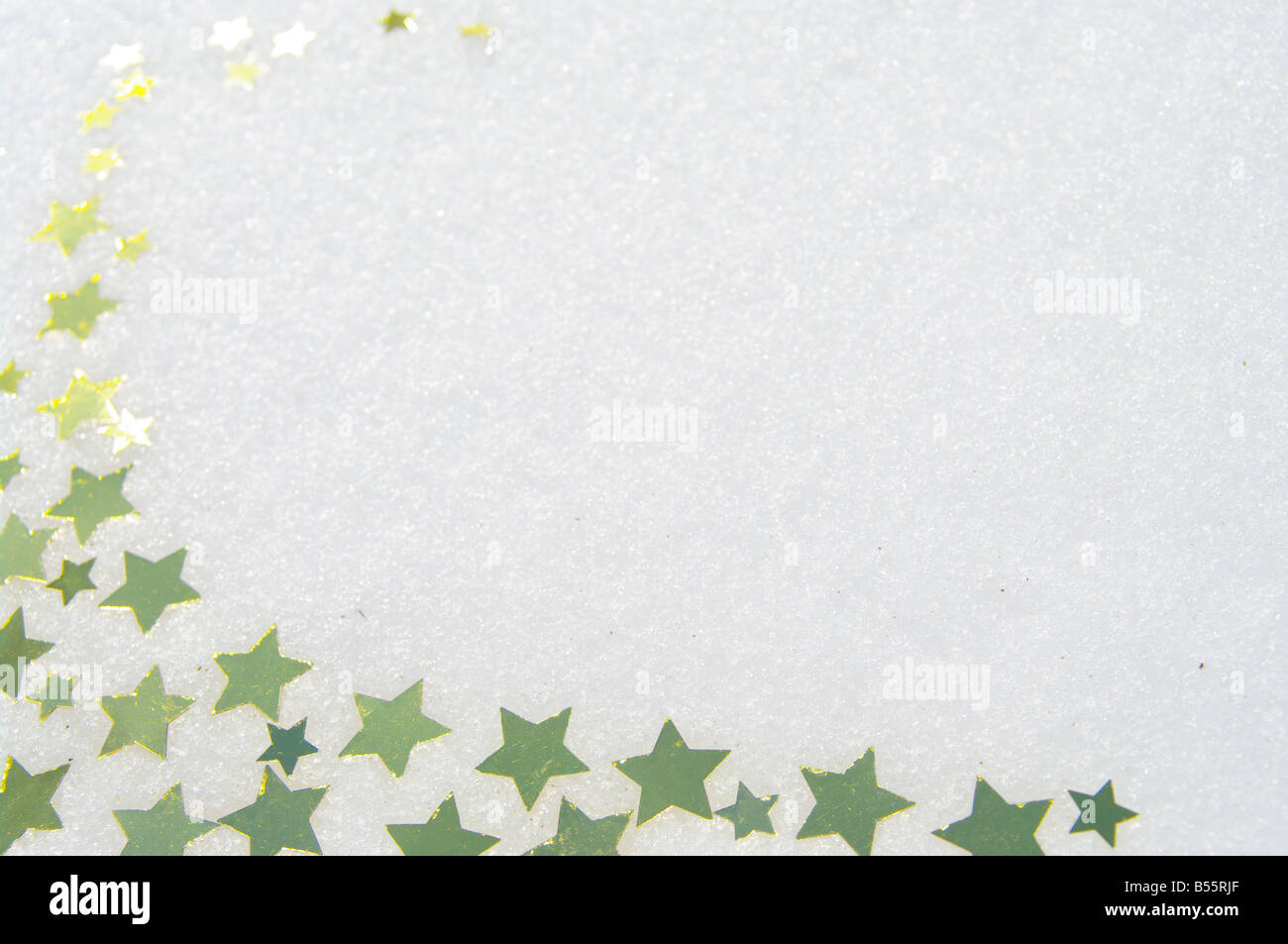 golden snow stars on a real snowy icy surface Stock Photo - Alamy