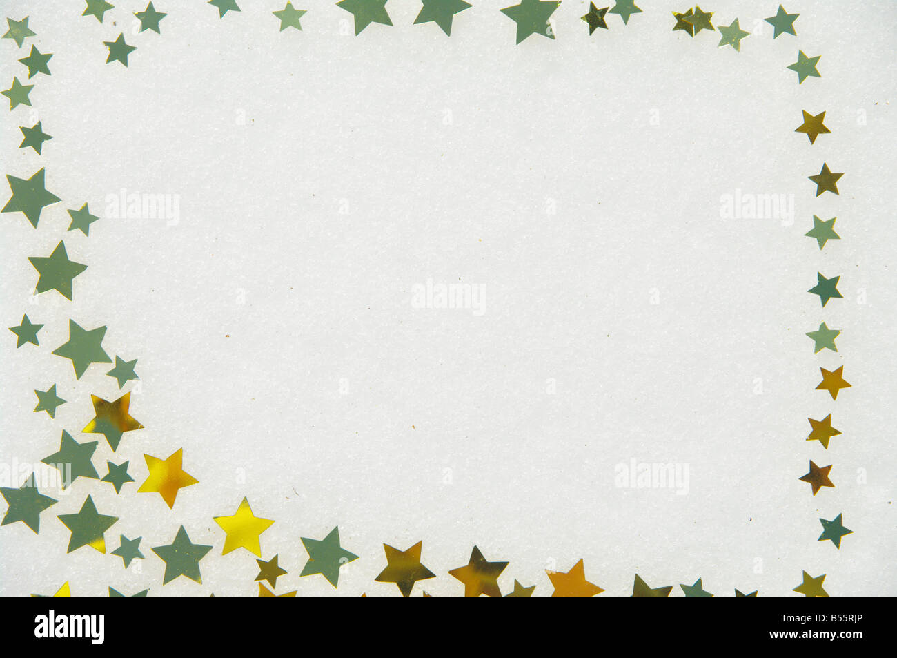 golden snow stars on a real snowy icy surface Stock Photo - Alamy