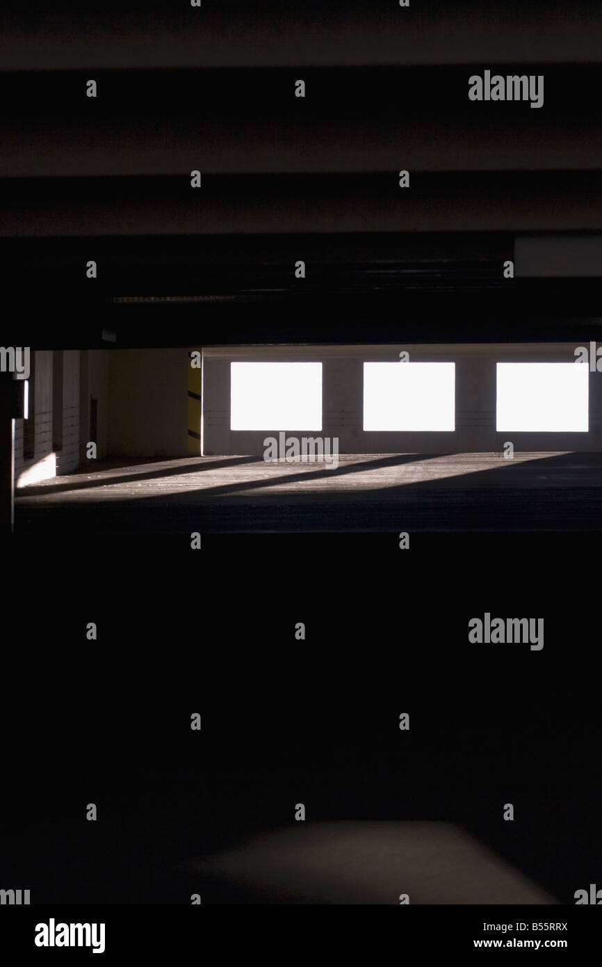 Morning light pouring through empty parking garage window Stock Photo ...
