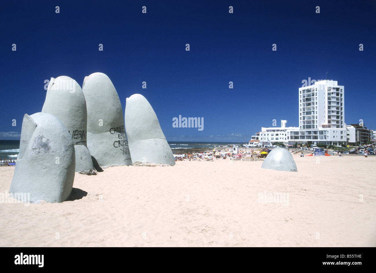 Fingers of the hand statue,La Mano, on the Playa Brava beach at Punta ...