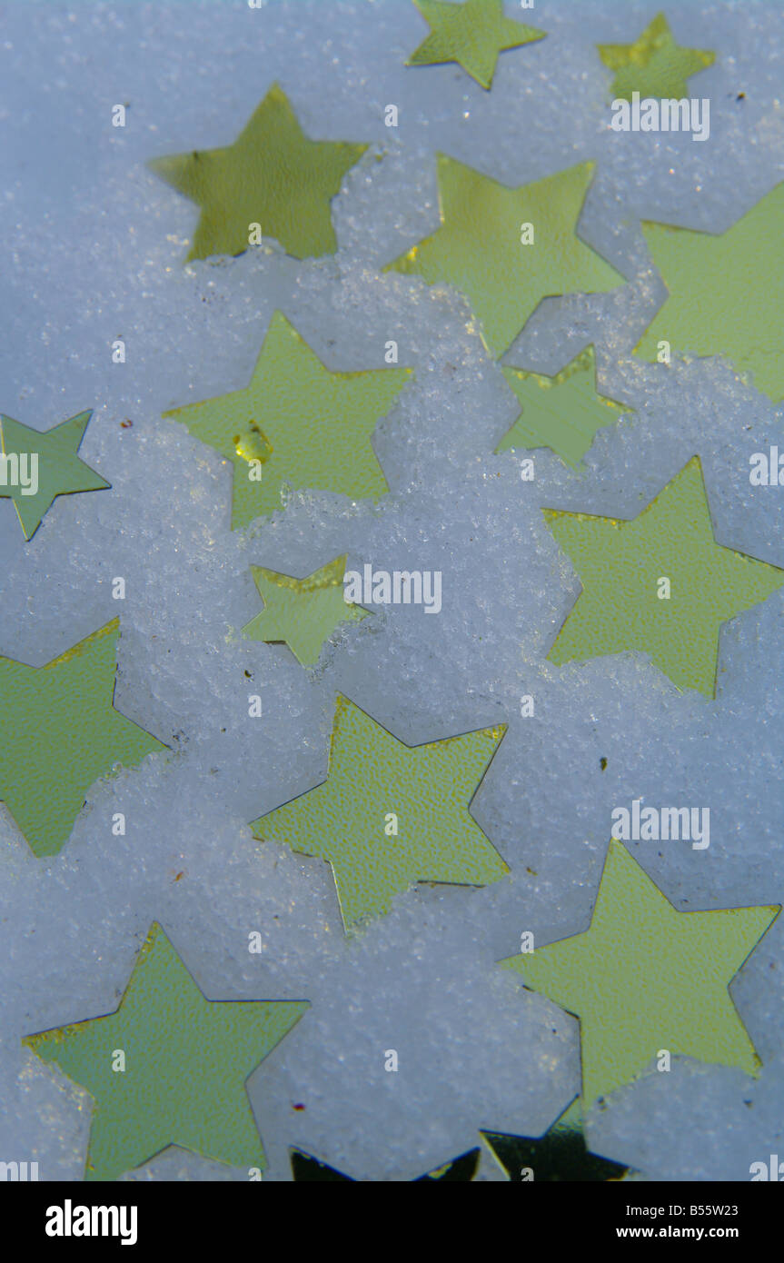 golden snow stars on a real snowy icy surface Stock Photo - Alamy