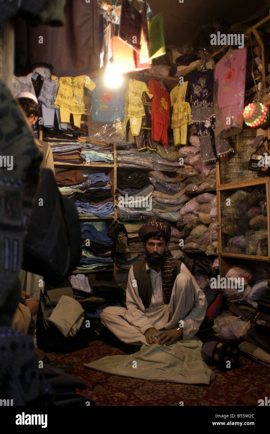 An Afghan man sits in his clothing store in the town of Gardez, Paktia ...