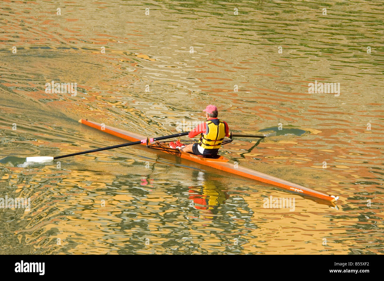 A single rower rowing along the Arno river in Florence Stock Photo - Alamy
