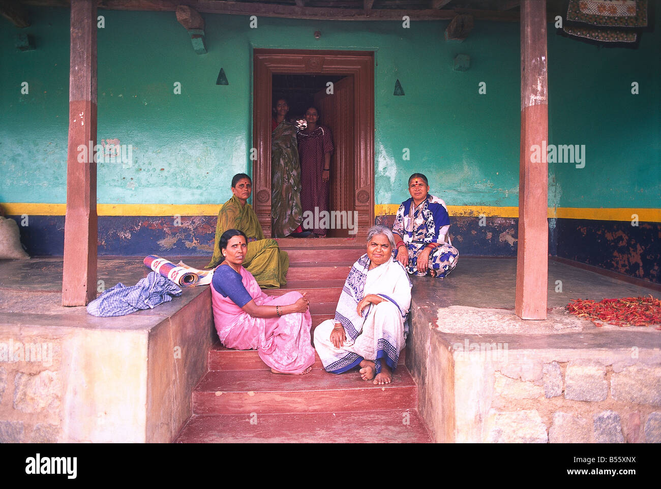 indian women outside traditional indian family home Stock Photo - Alamy
