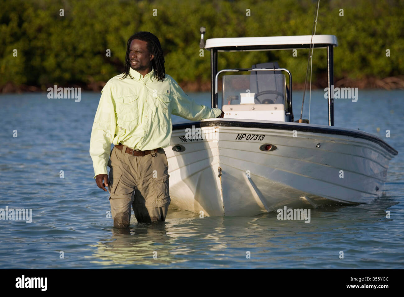 Bonefishing guide Shawn Leadon with his boat in shallow waters near the ...