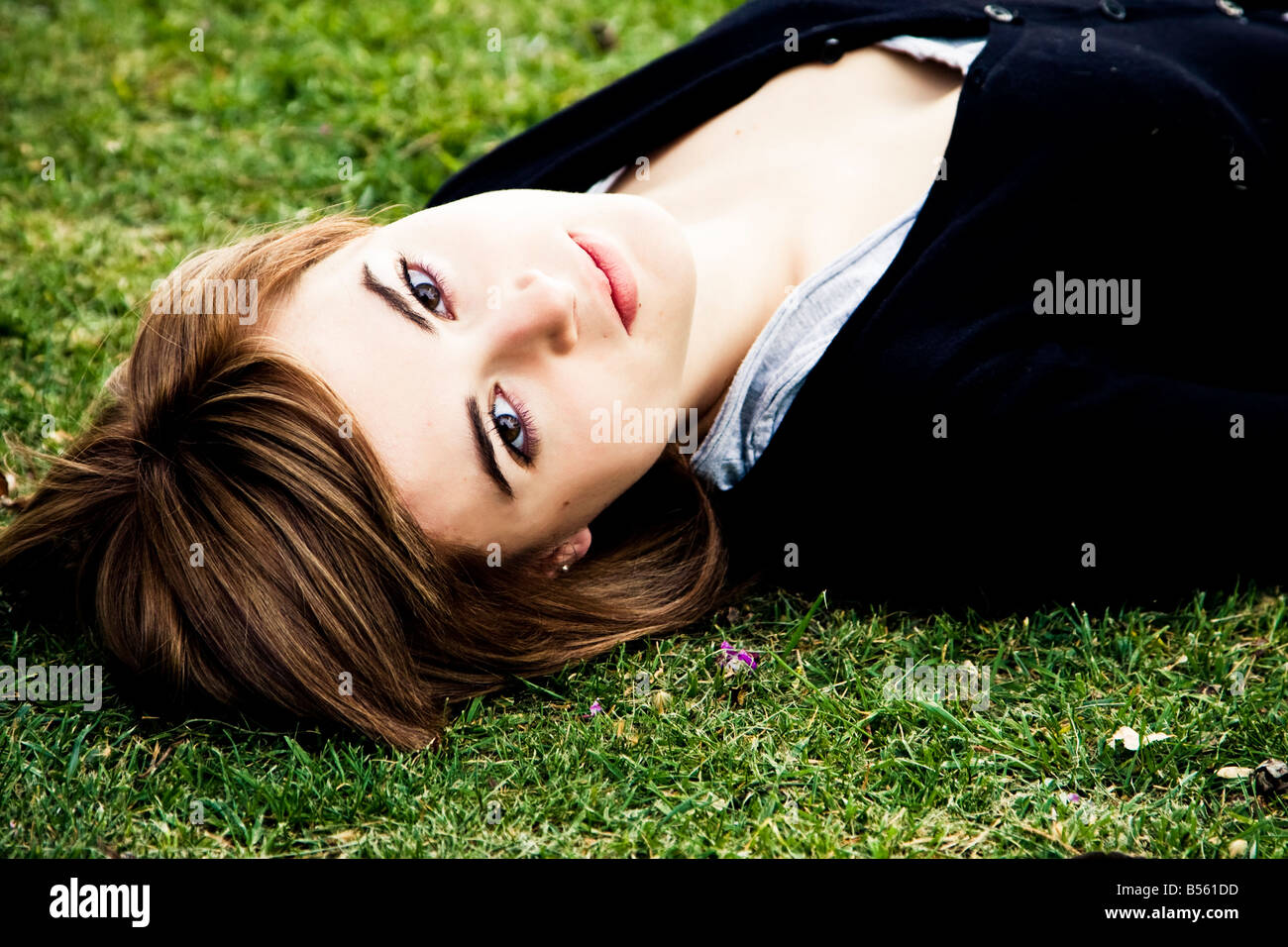 Laying woman staring at camera Stock Photo - Alamy