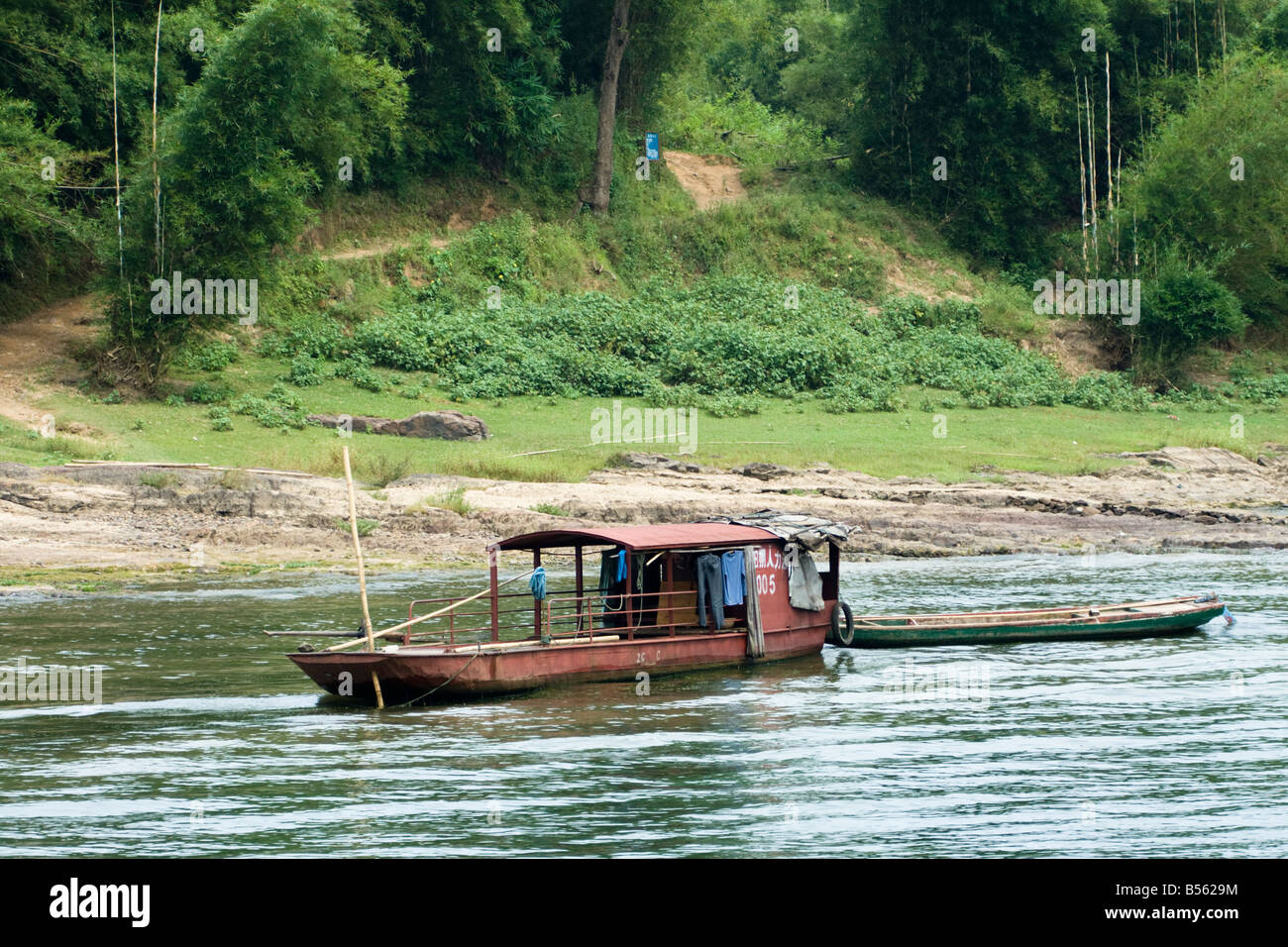 A small traditional Chinese boat of the Li River, China with clothes ...