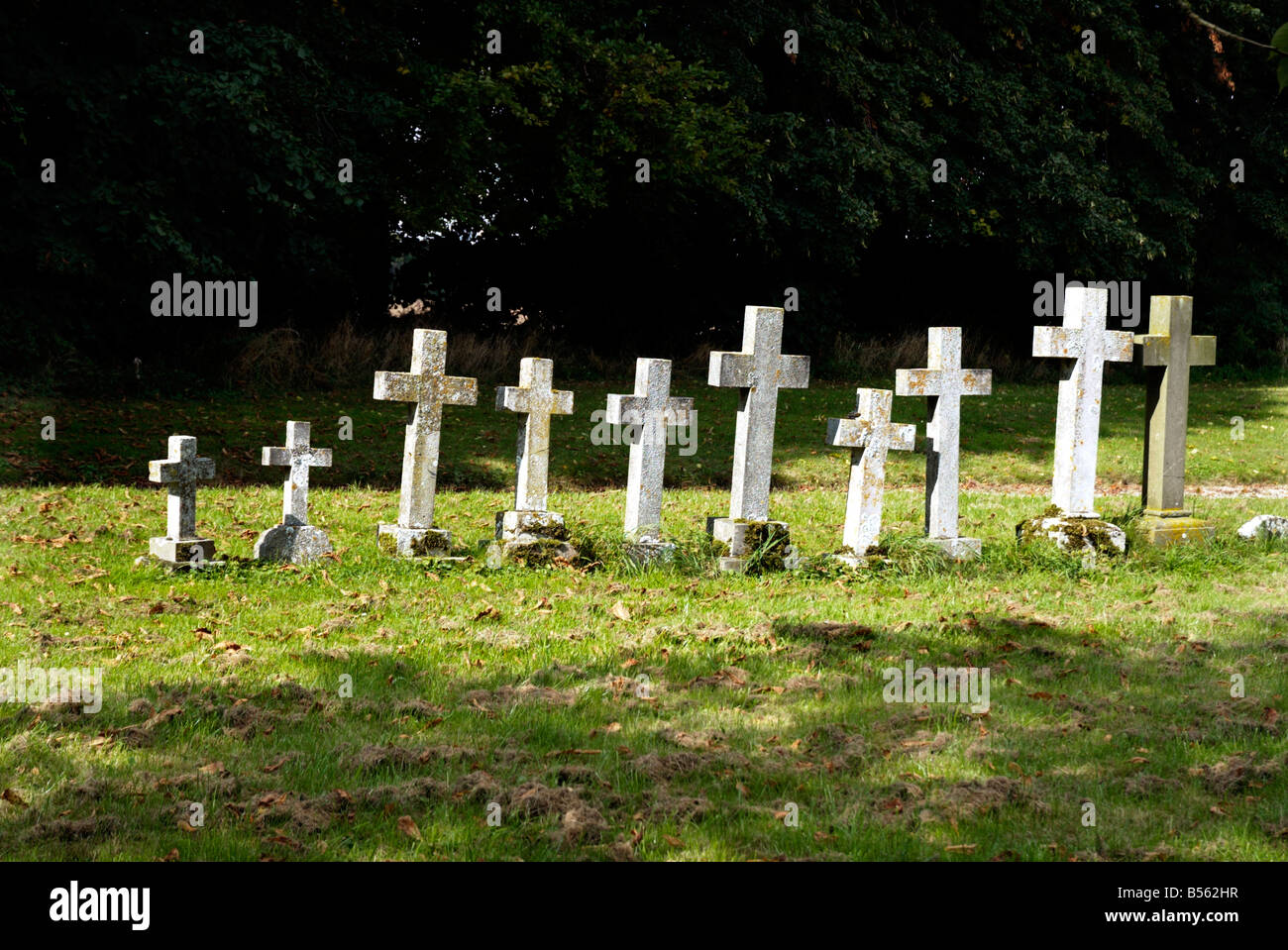row of different size headstone crosses in graveyard at Honingham ...