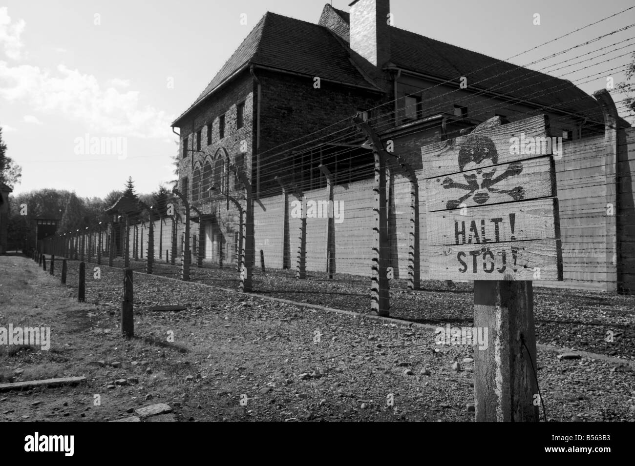 Warning stop sign with skull&bones symbol in front of barbed wire ...