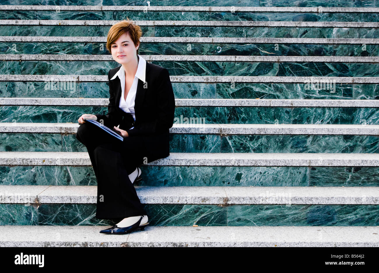 Smiling businessman over marble steps background Stock Photo - Alamy