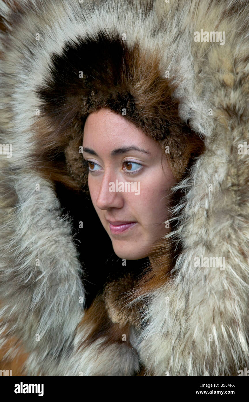 Athabaskan indian girl showing closeup of fur hood on handmade parka ...