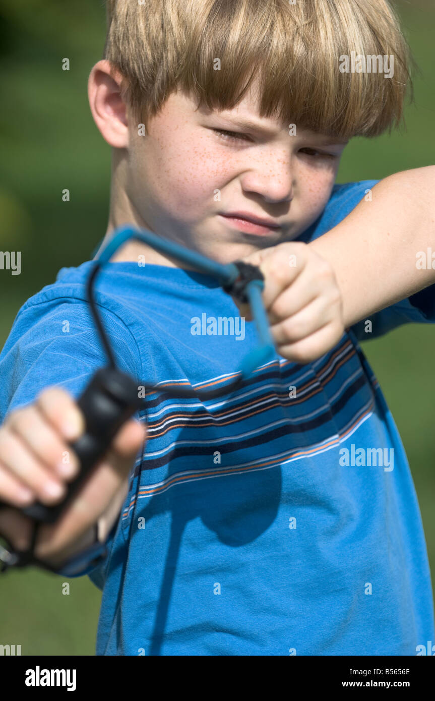 Young boy with slingshot Stock Photo - Alamy