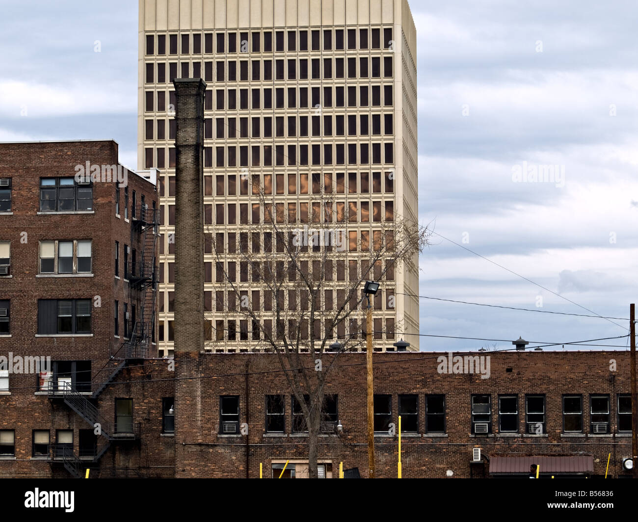 Old and new brick buildings under a striped cloudy sky Stock Photo - Alamy