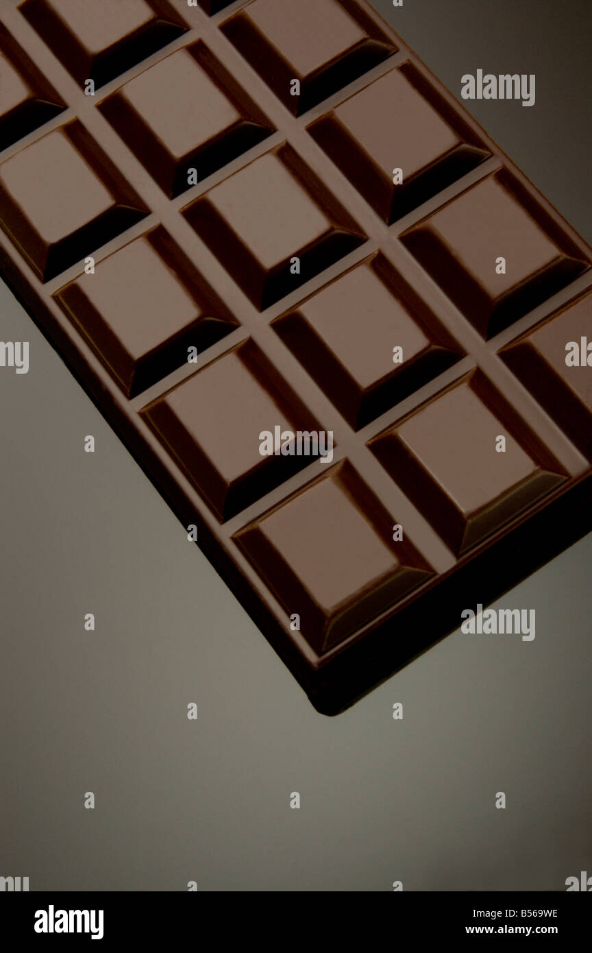 Chocolate bar on top of dark chocolate syrup Stock Photo - Alamy