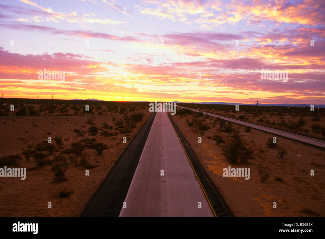 Straight road through desert sunset hi-res stock photography and images ...