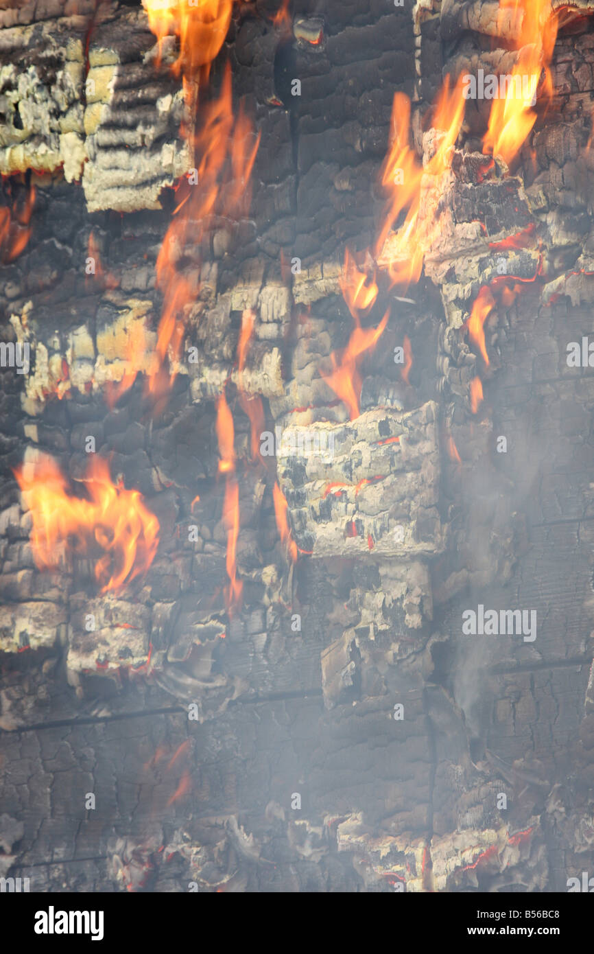 The siding of a house that is burning down Smoke has appeared creating ...
