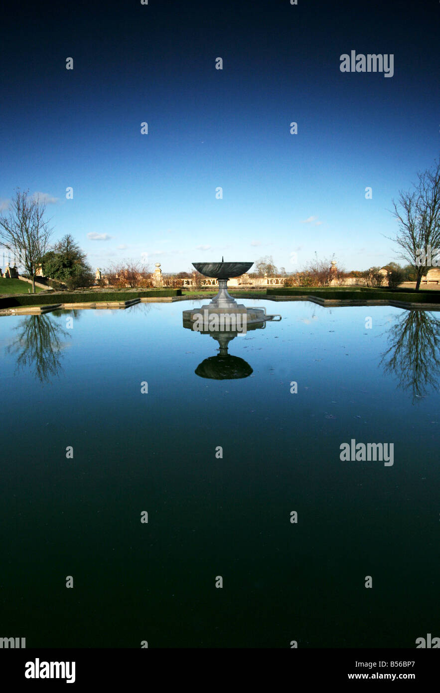 An ornate fountain reflected in an ornamental water feature Stock Photo ...