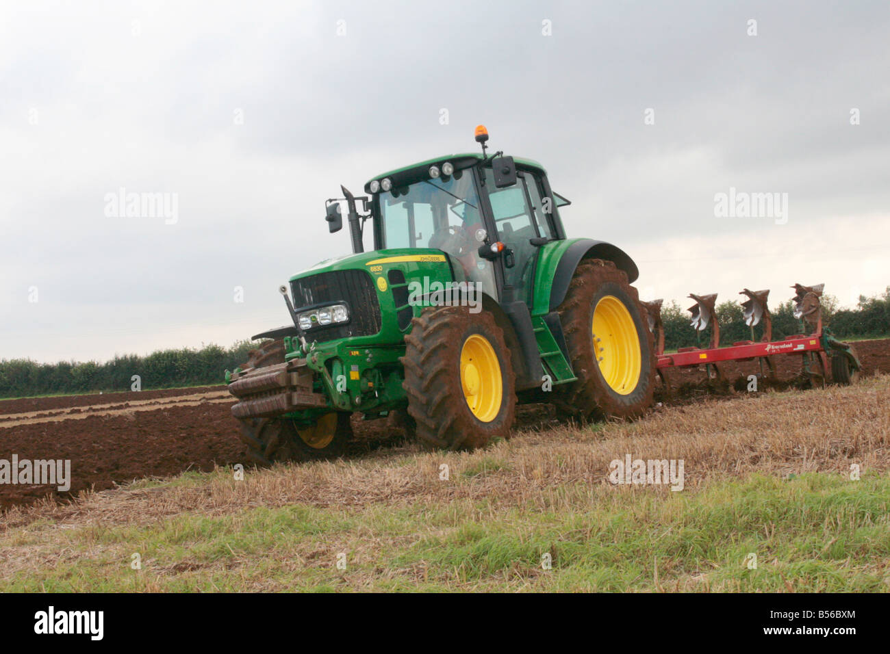 John Deer tractor and reversible plough Stock Photo - Alamy