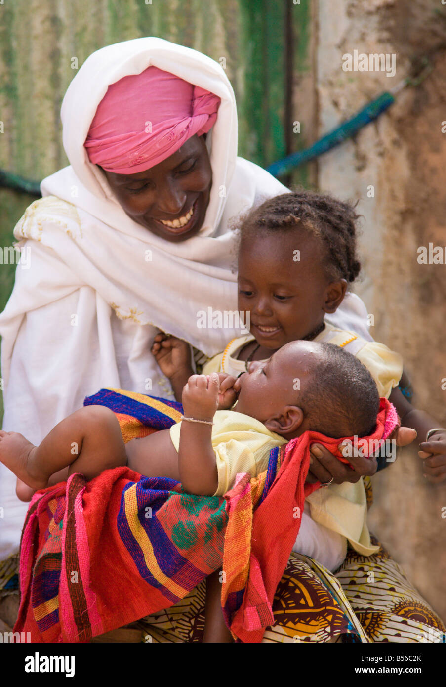 A Fulani woman in Ouagadougou Burkina Faso holds her two youngest ...