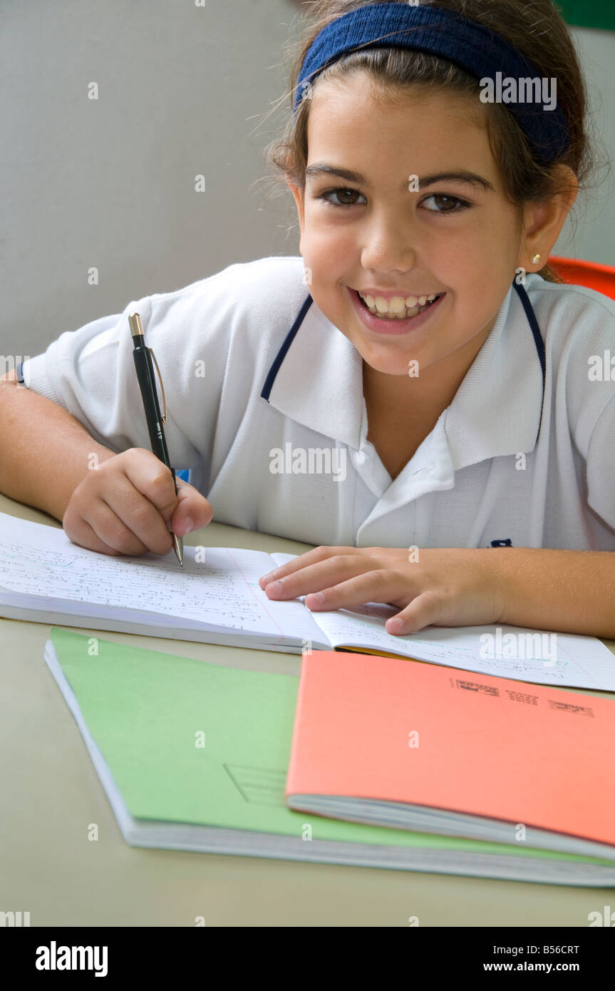 Smiling as she writes hi-res stock photography and images - Alamy