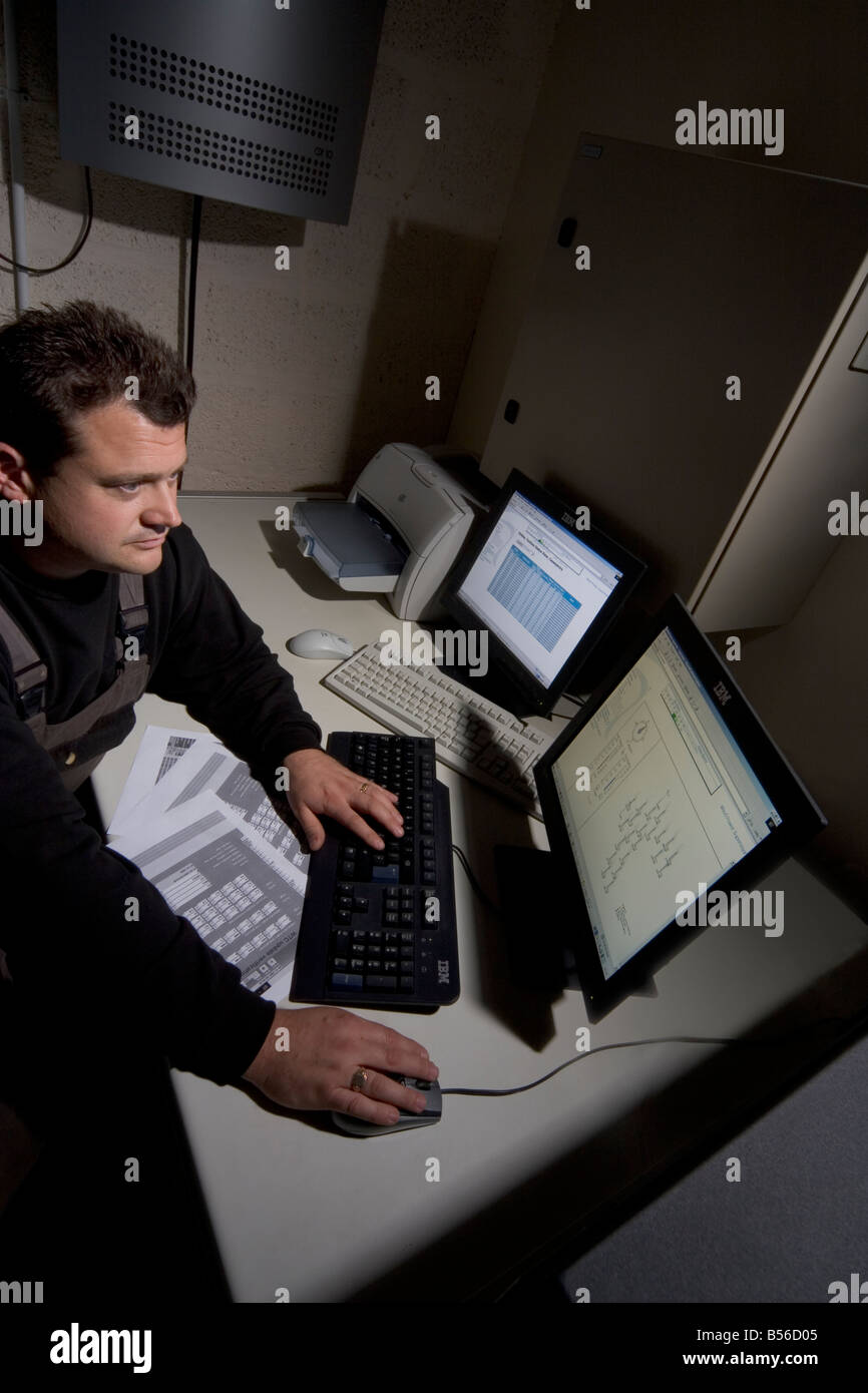 Computerised wind farm control room interior with controller monitoring ...
