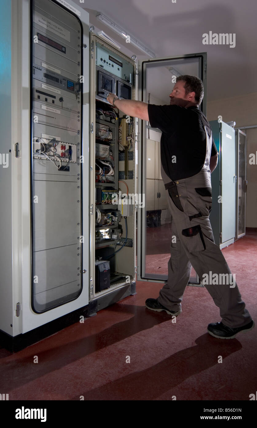 Engineer in electricity substation providing electrical power to the ...