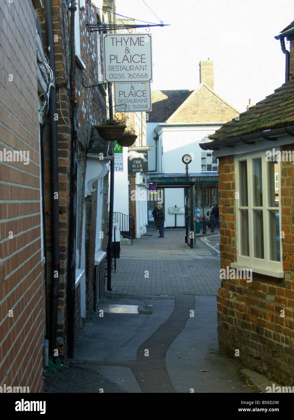 Small backstree alleyway with shop signs Wantage. Oxon Stock Photo - Alamy