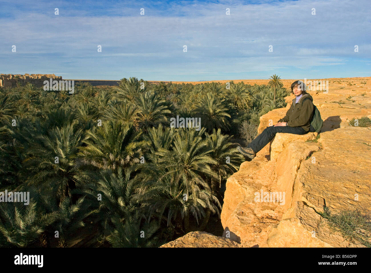 Young woman sits above oasis in African desert, Source Bleue de Meski ...