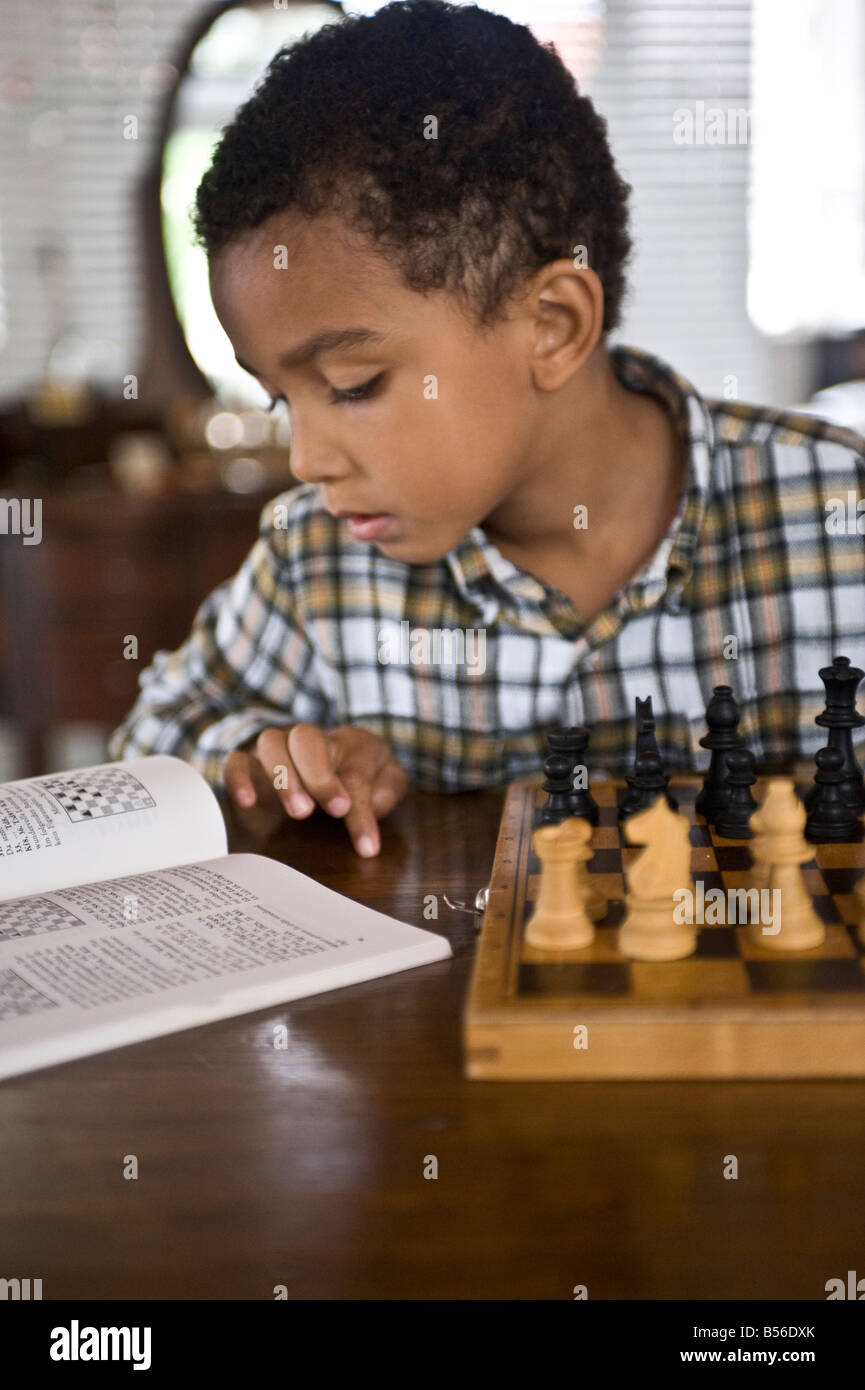 Young boy learning chess Stock Photo - Alamy