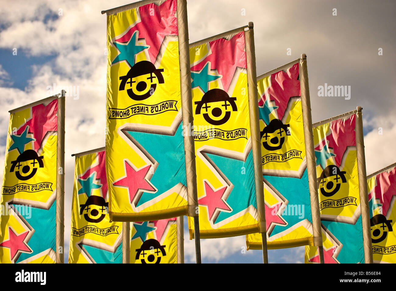 Repating bright circus flags blowing in the wind Stock Photo - Alamy