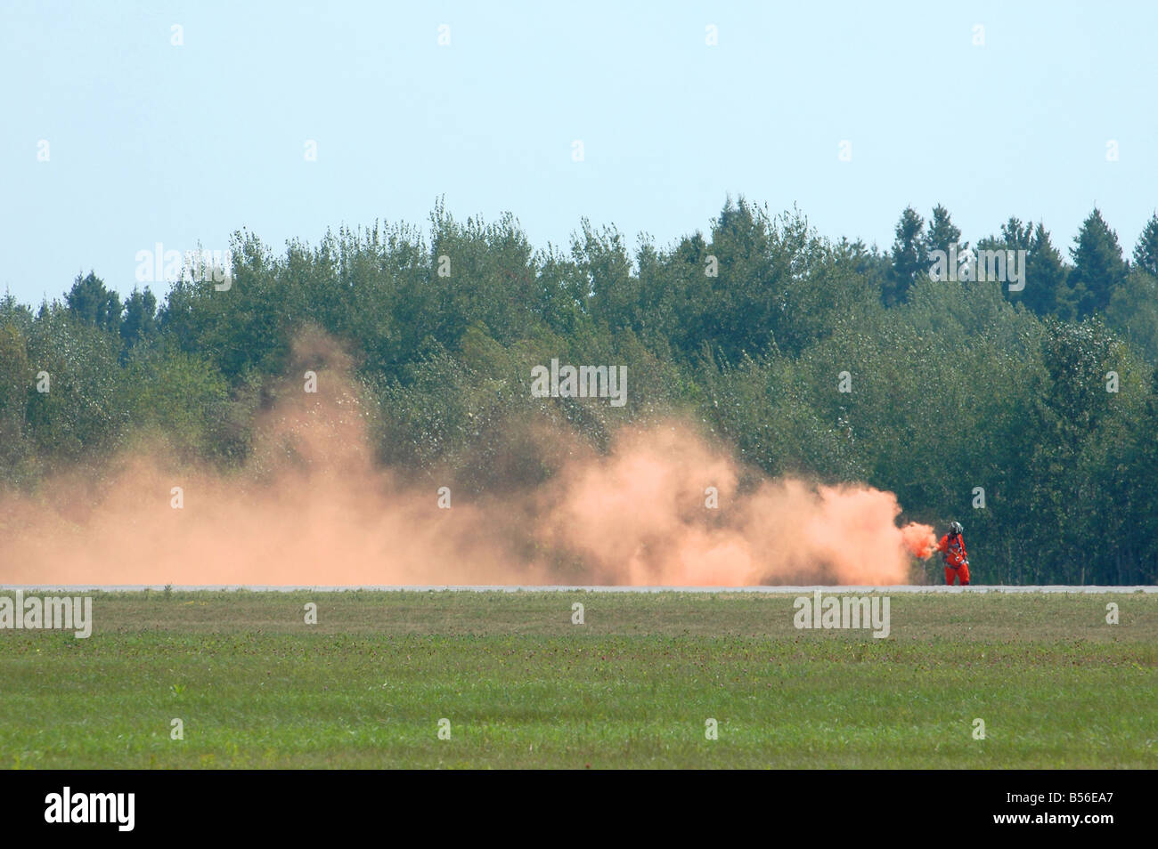 Canadian Search and Rescue member lights a smoke signal for helicopter ...