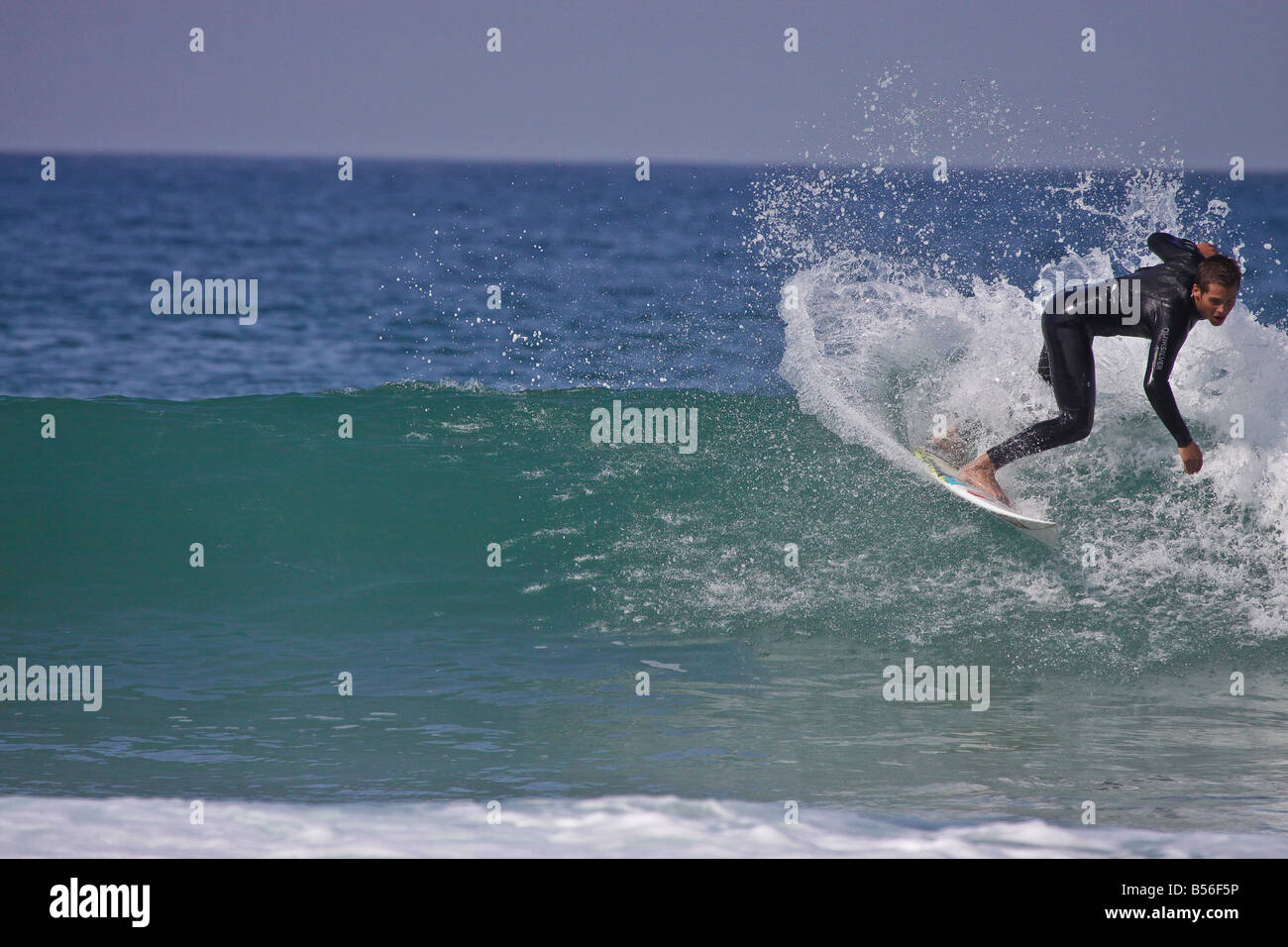 Surfer riding a wave Stock Photo - Alamy