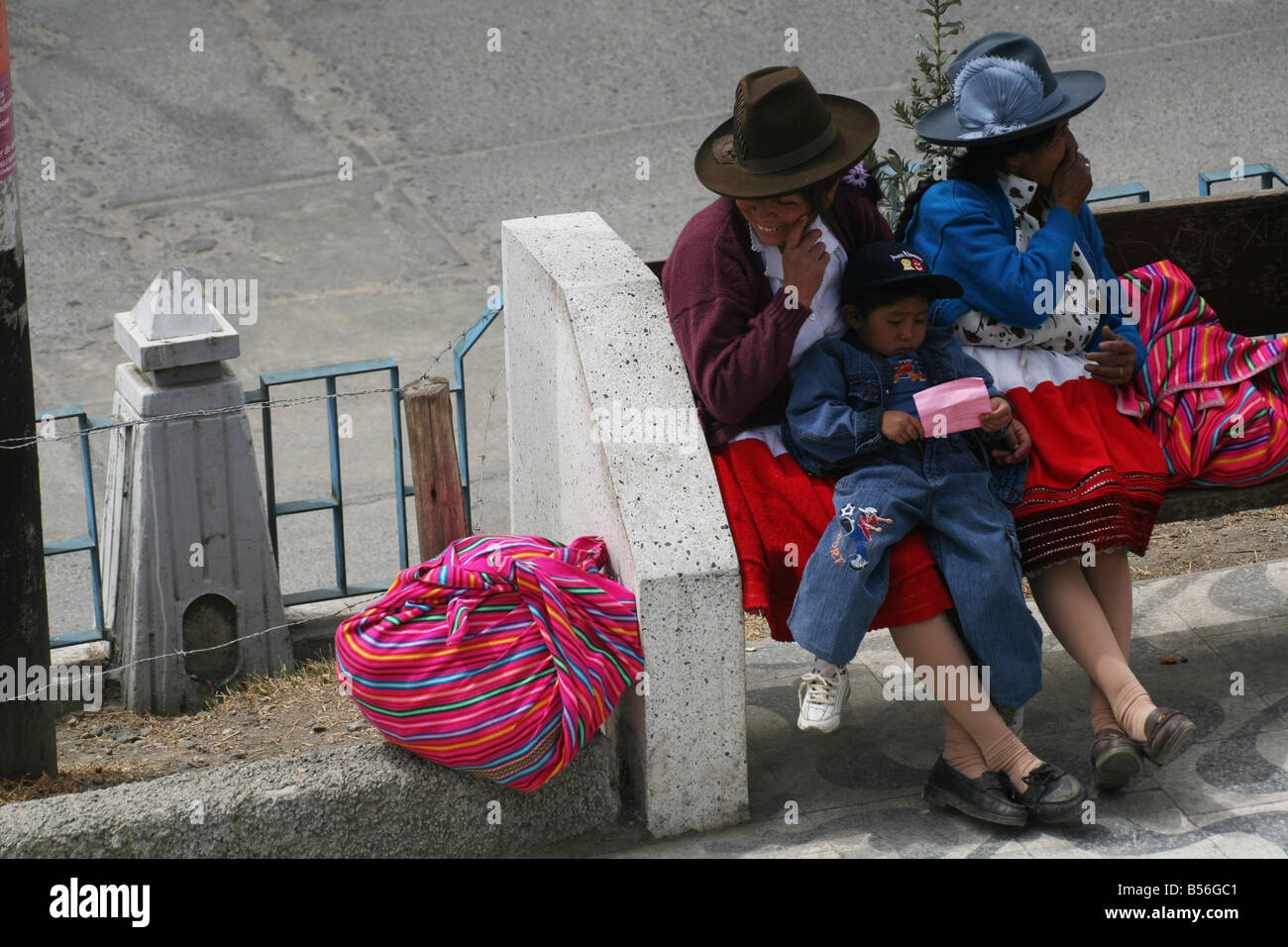 Three Generations of a Quechua Family Sit on a Bench in Huaraz, Peru ...