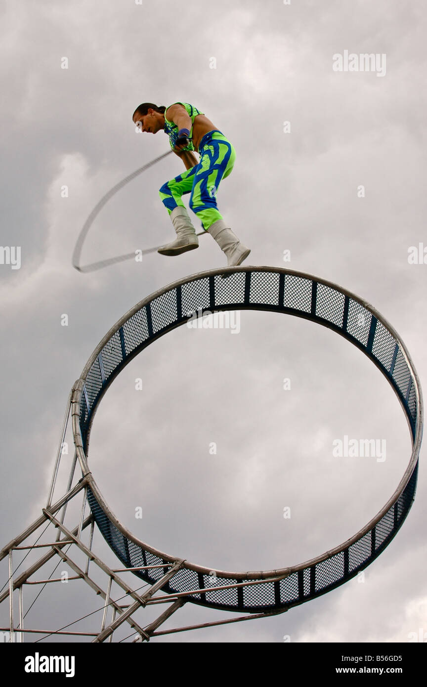 A circus performer jump ropes ontop of a rotating contraption Stock ...