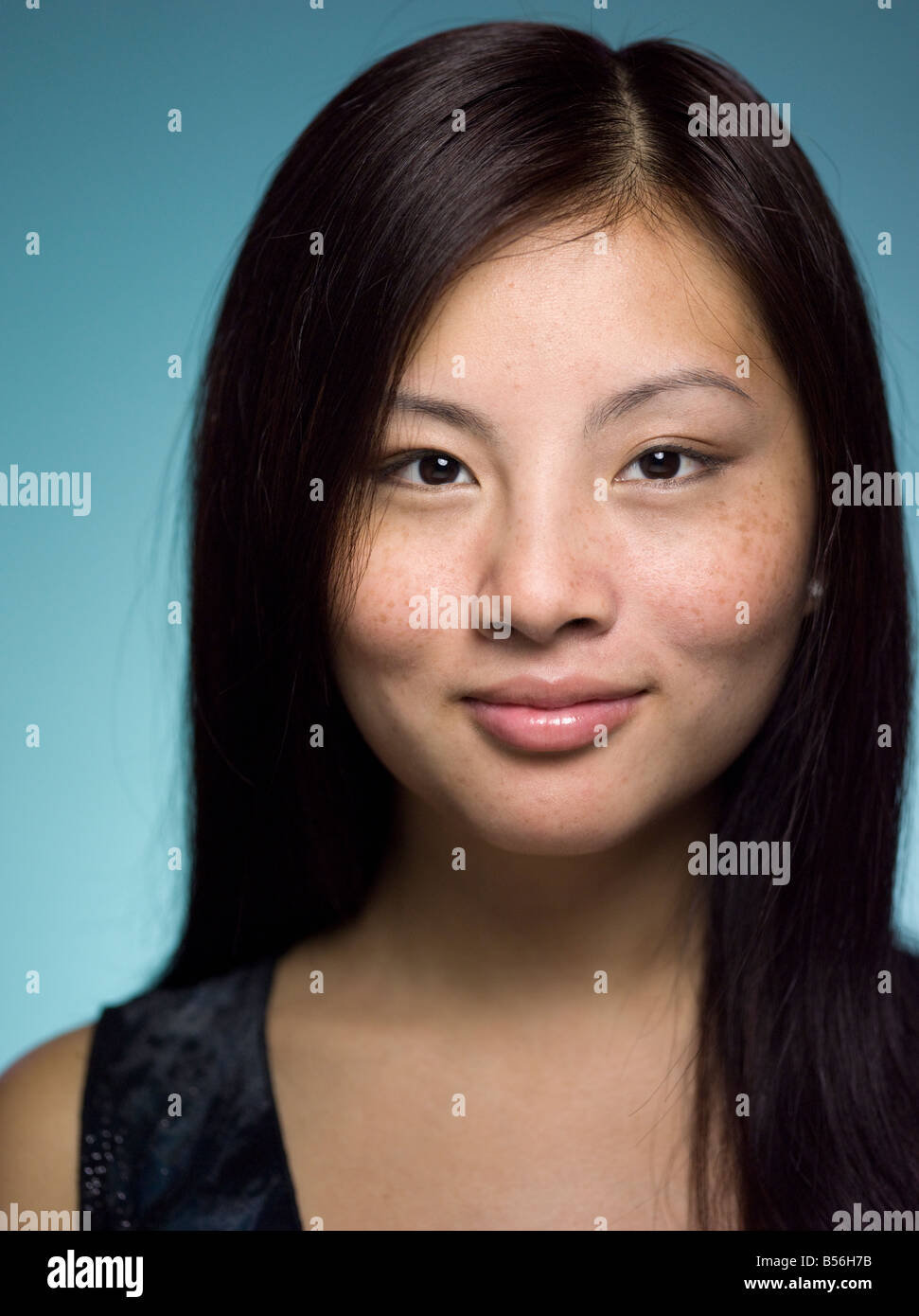 Close-up portrait of young and confident Chinese woman in a studio ...