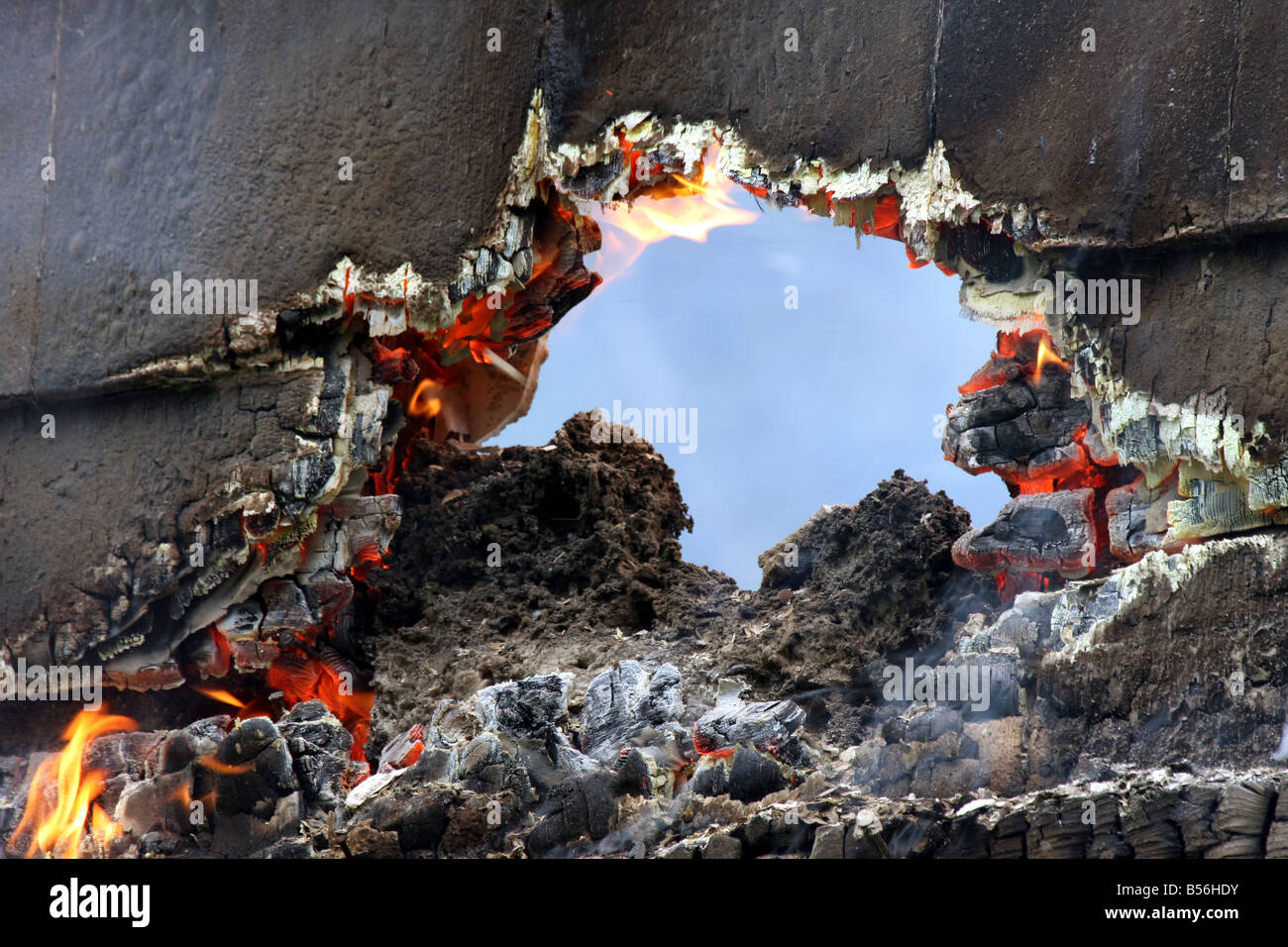 A hole in the exterior wall of a house on fire Stock Photo - Alamy