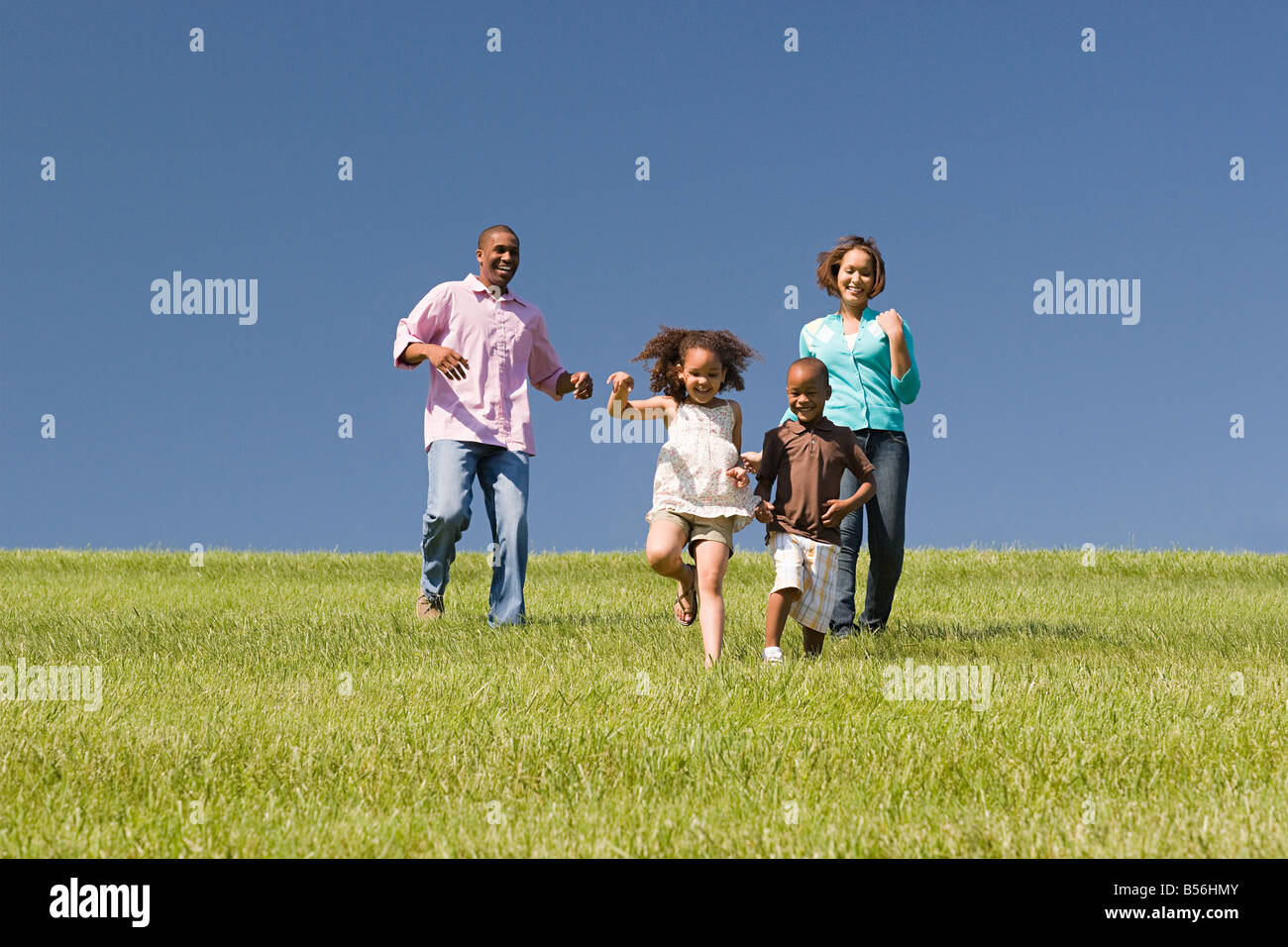 Family in a field Stock Photo - Alamy