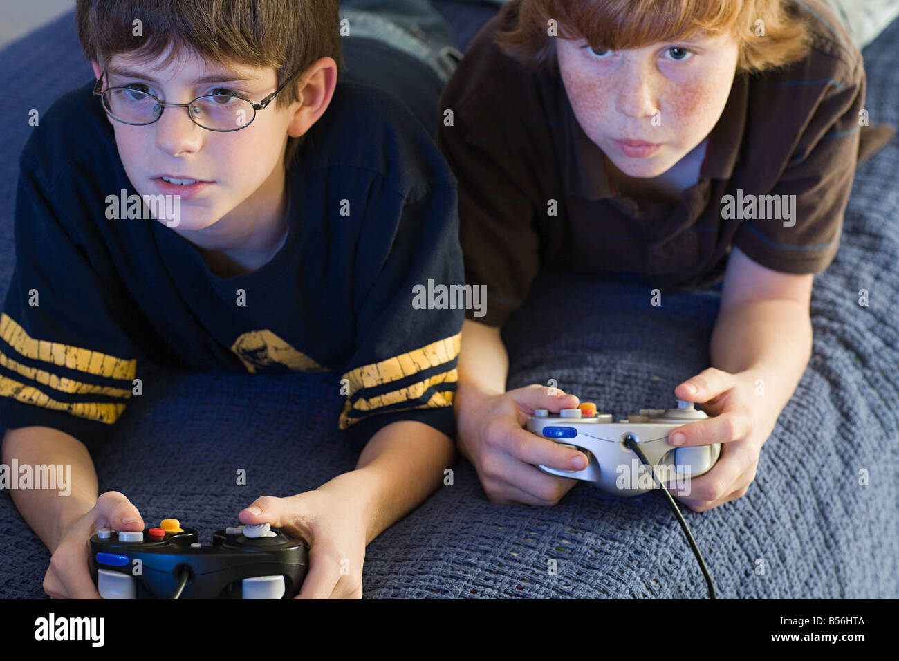 Two boys playing a video game Stock Photo - Alamy