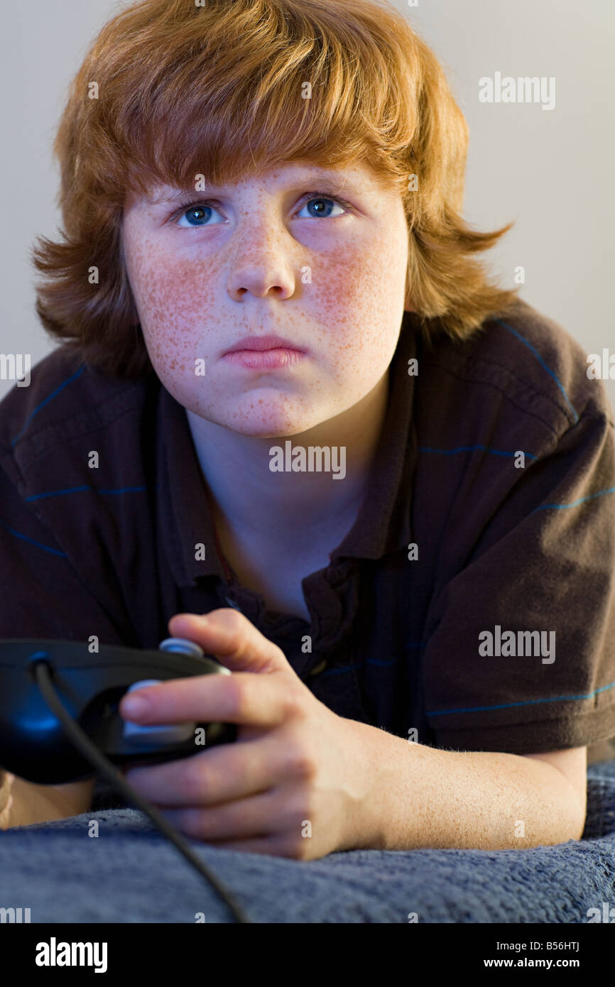 A boy playing a video game Stock Photo - Alamy